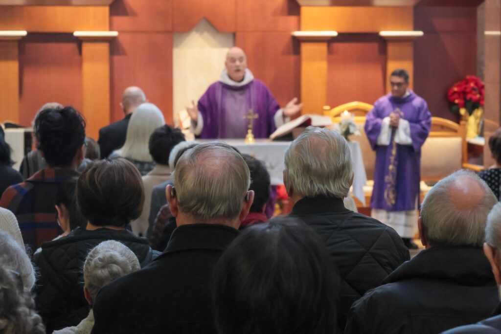 Families remember loved ones during Advent Mass at Holy Cross Cemetery ...