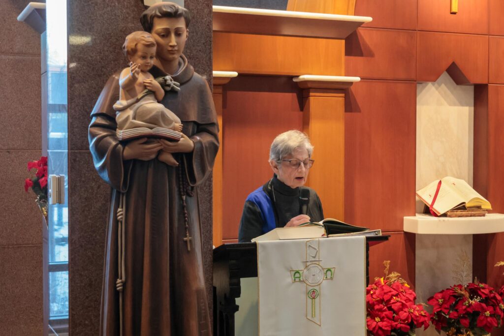 Families remember loved ones during Advent Mass at Holy Cross Cemetery ...