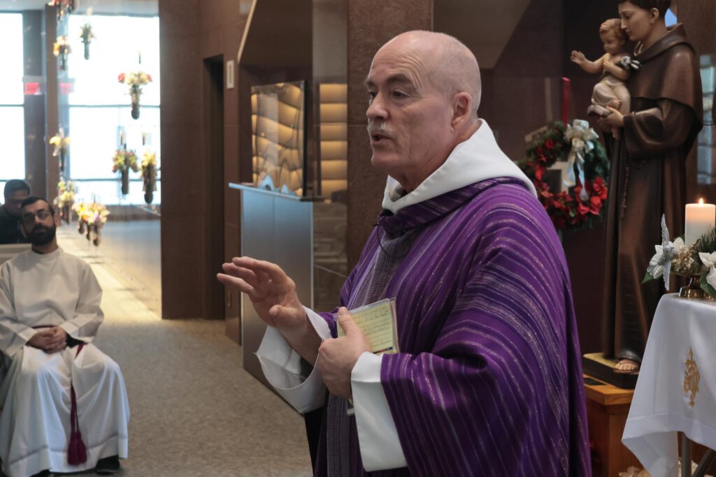Families remember loved ones during Advent Mass at Holy Cross Cemetery ...