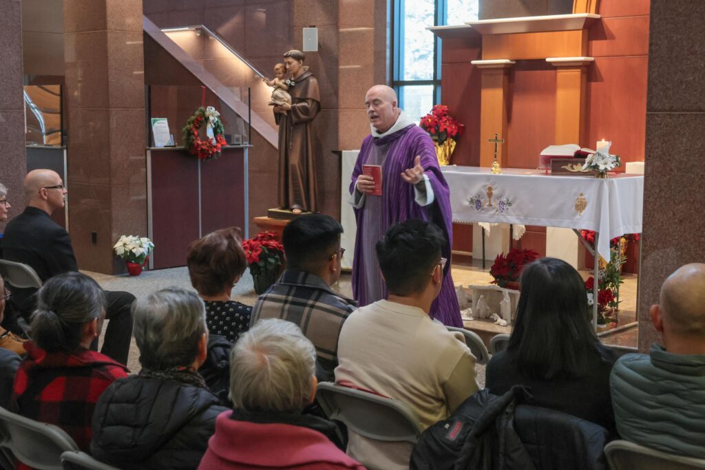 Families remember loved ones during Advent Mass at Holy Cross Cemetery ...
