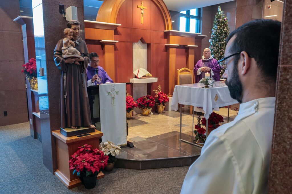 Families remember loved ones during Advent Mass at Holy Cross Cemetery ...