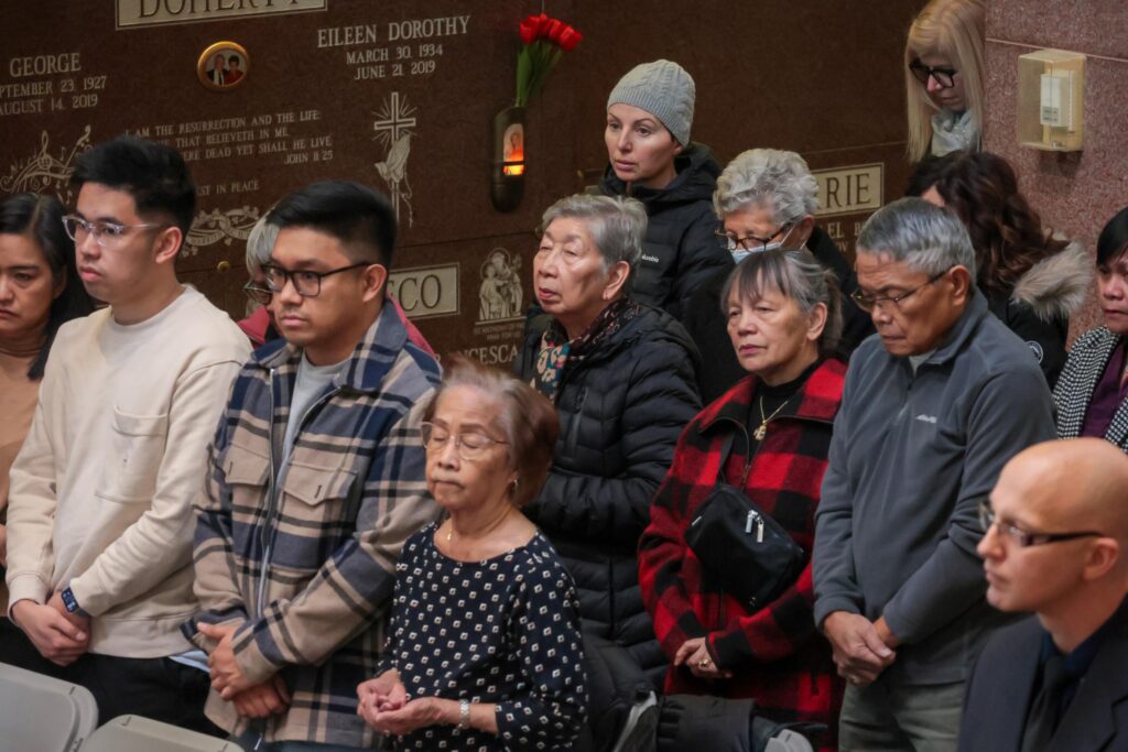 Families remember loved ones during Advent Mass at Holy Cross Cemetery ...