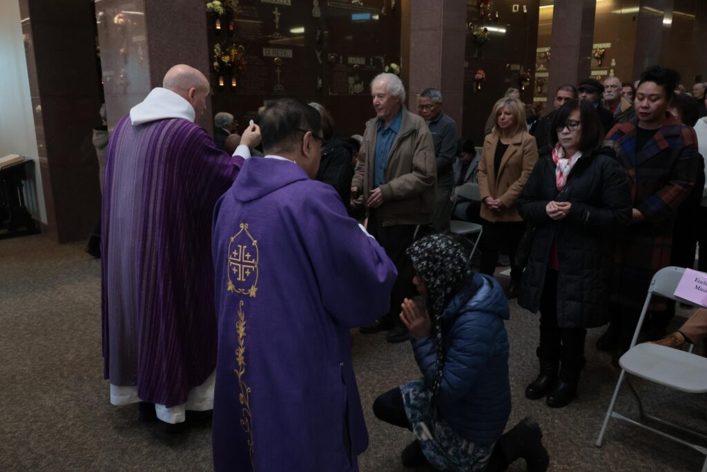 Families remember loved ones during Advent Mass at Holy Cross Cemetery ...