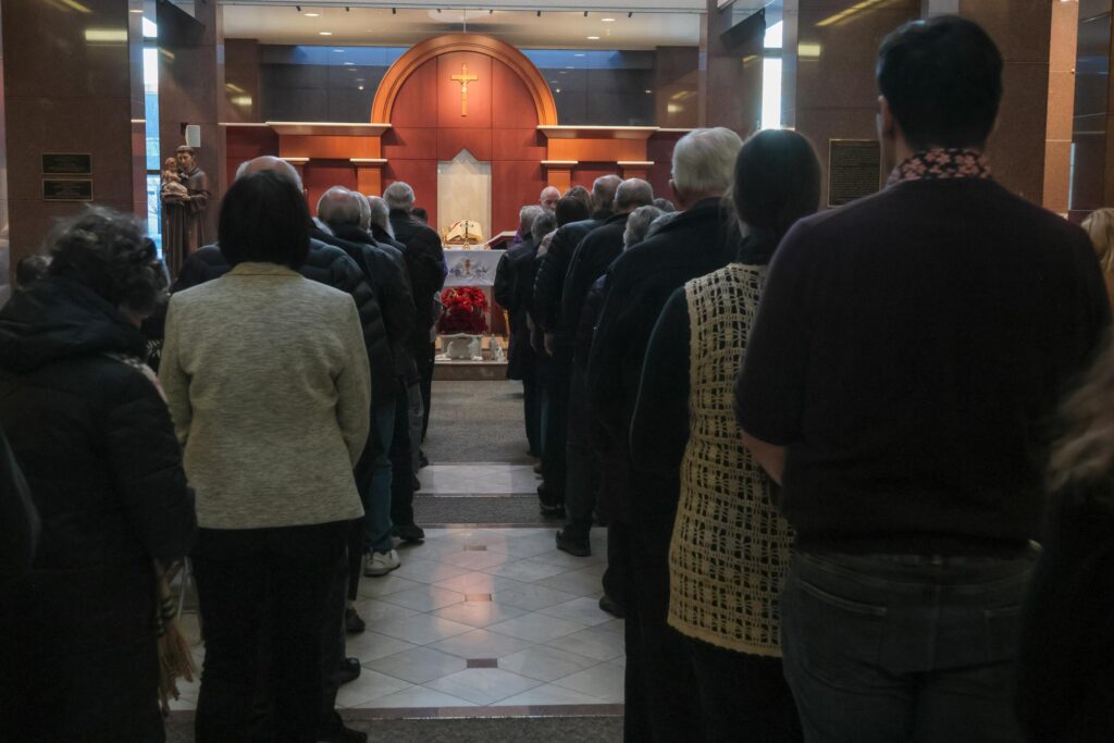 Families remember loved ones during Advent Mass at Holy Cross Cemetery ...