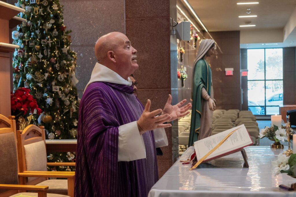 Families remember loved ones during Advent Mass at Holy Cross Cemetery ...